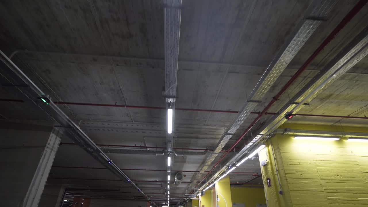 Premium stock video - Underground parking lot garage ceiling automated ...