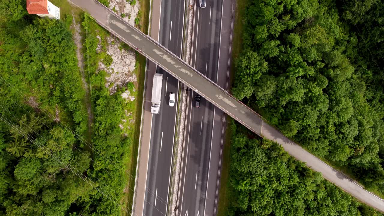 Top-down drone shot of lightly wet european highway with overpass and ...