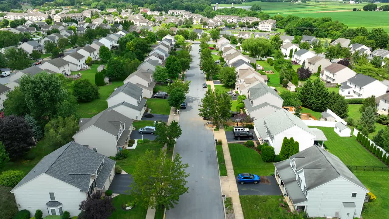 An American suburban neighborhood stretches out, with neat houses ...