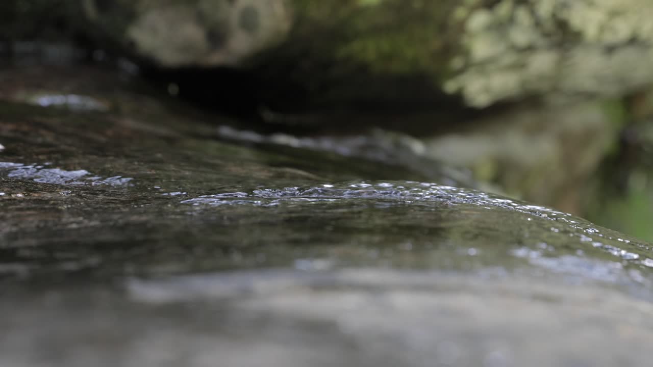 Close up of water trickling down rock at waterfall slow motion Premium ...