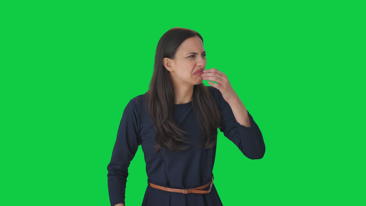 Indian girl disturbed by bad smell green screen Premium Stock Video Footage