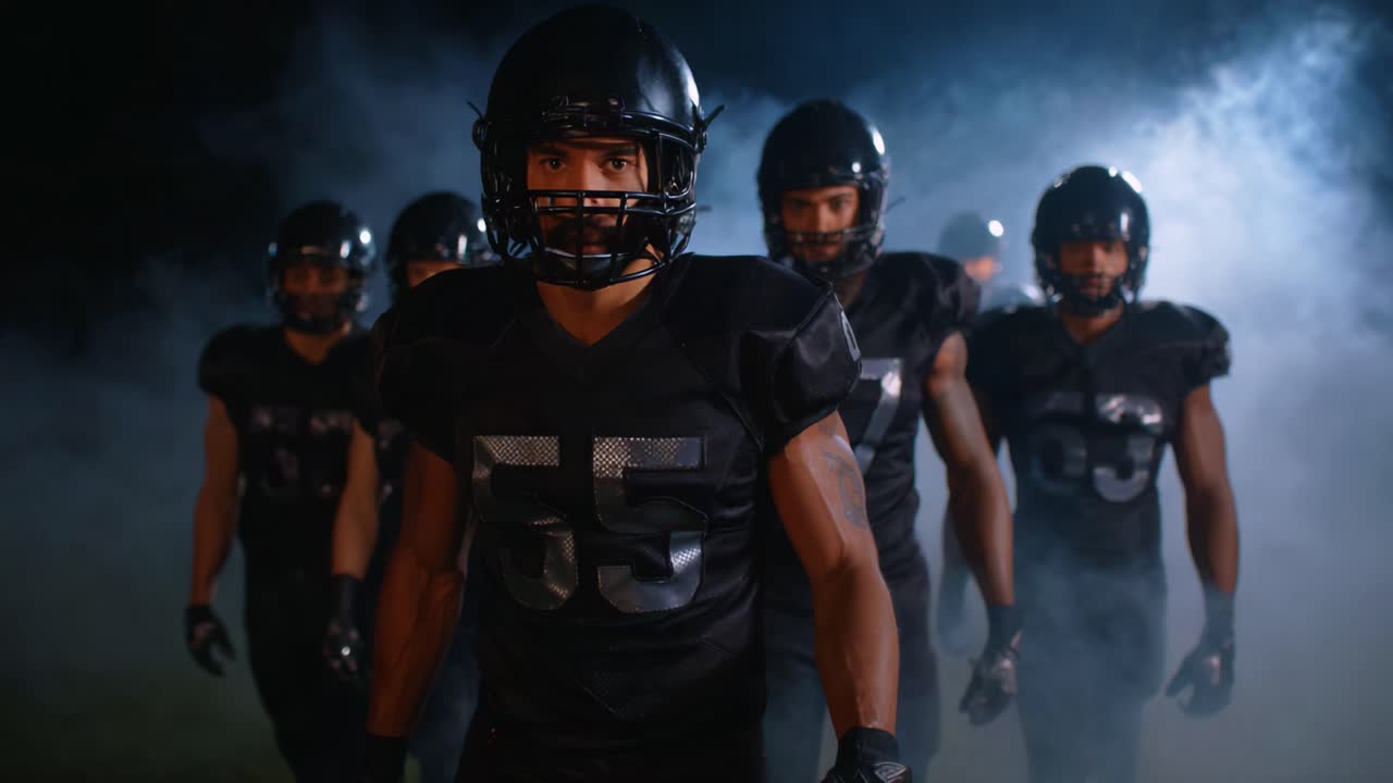 A Team of Determined Football Players in Black Uniforms Advances ...