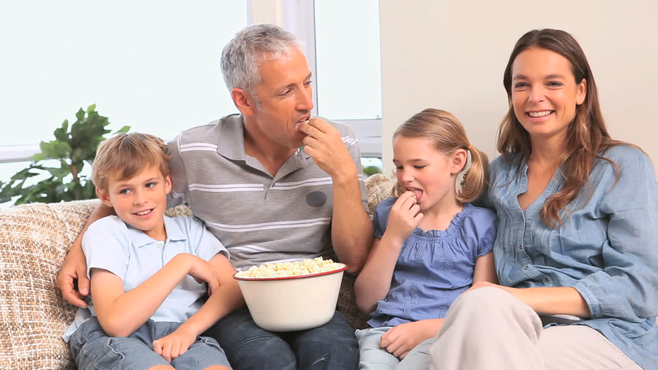 Premium stock video - Family watching a movie