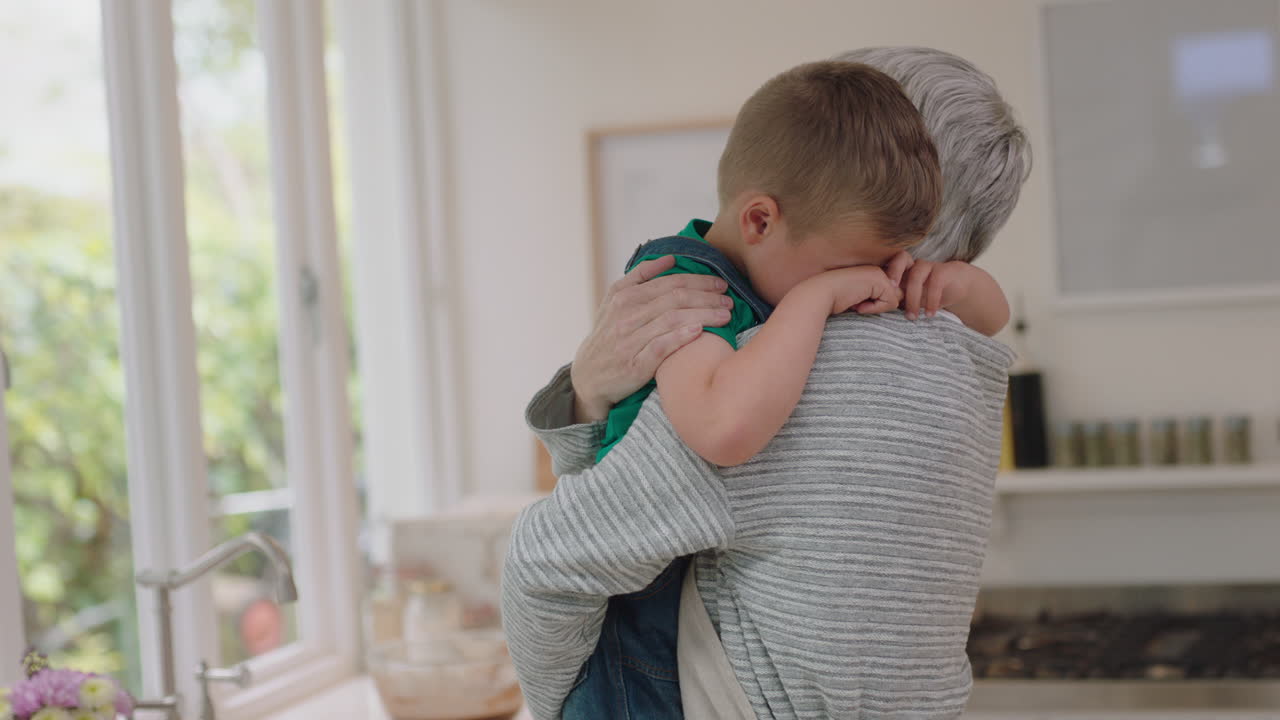 Premium stock video - Grandmother hugging little boy crying embracing ...