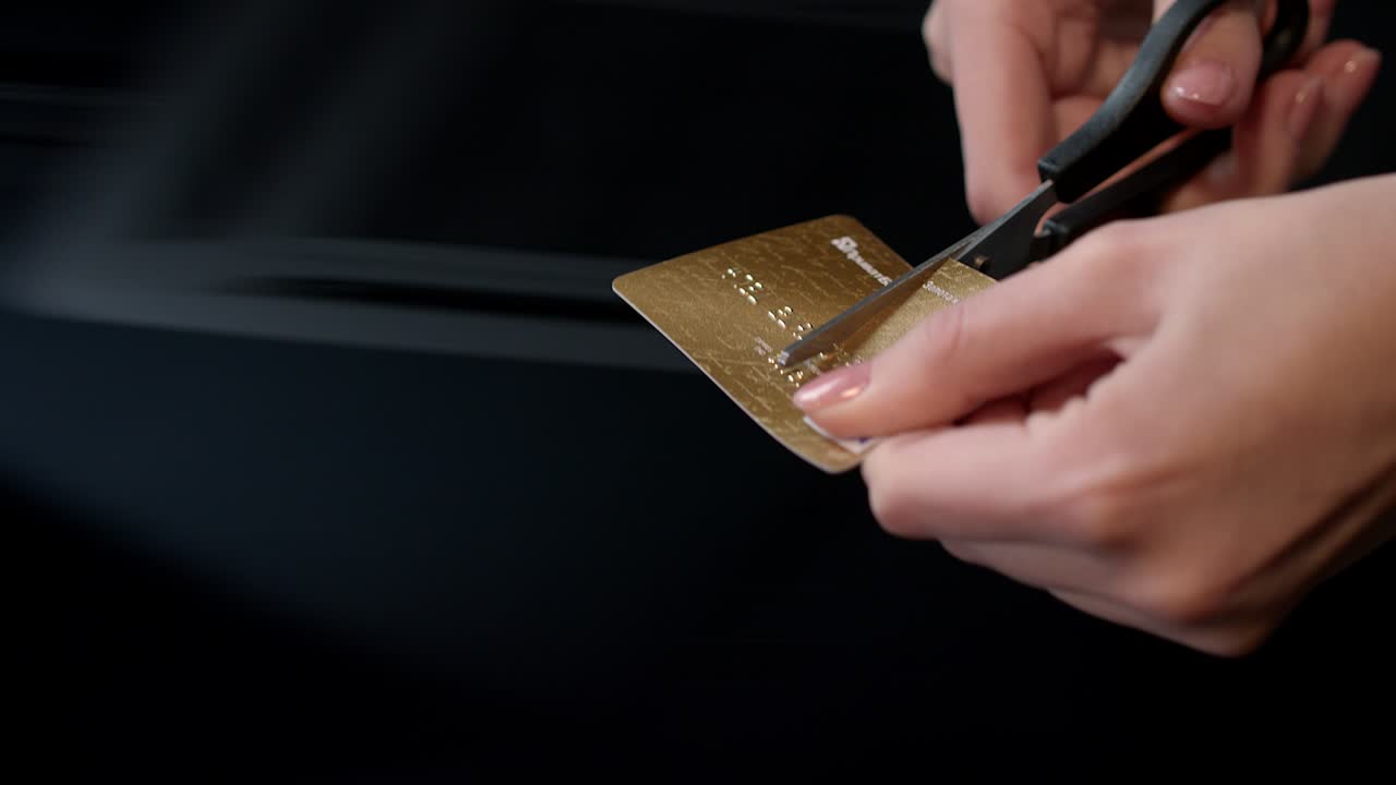 Female hands cutting credit card with scissors. debit card account ...