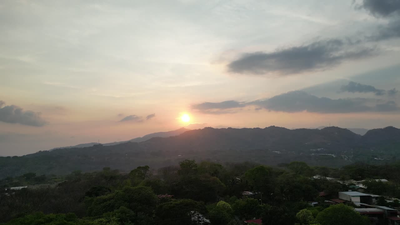 Drone Shot Rising Over Tree in Foreground Revealing Sunset Over ...