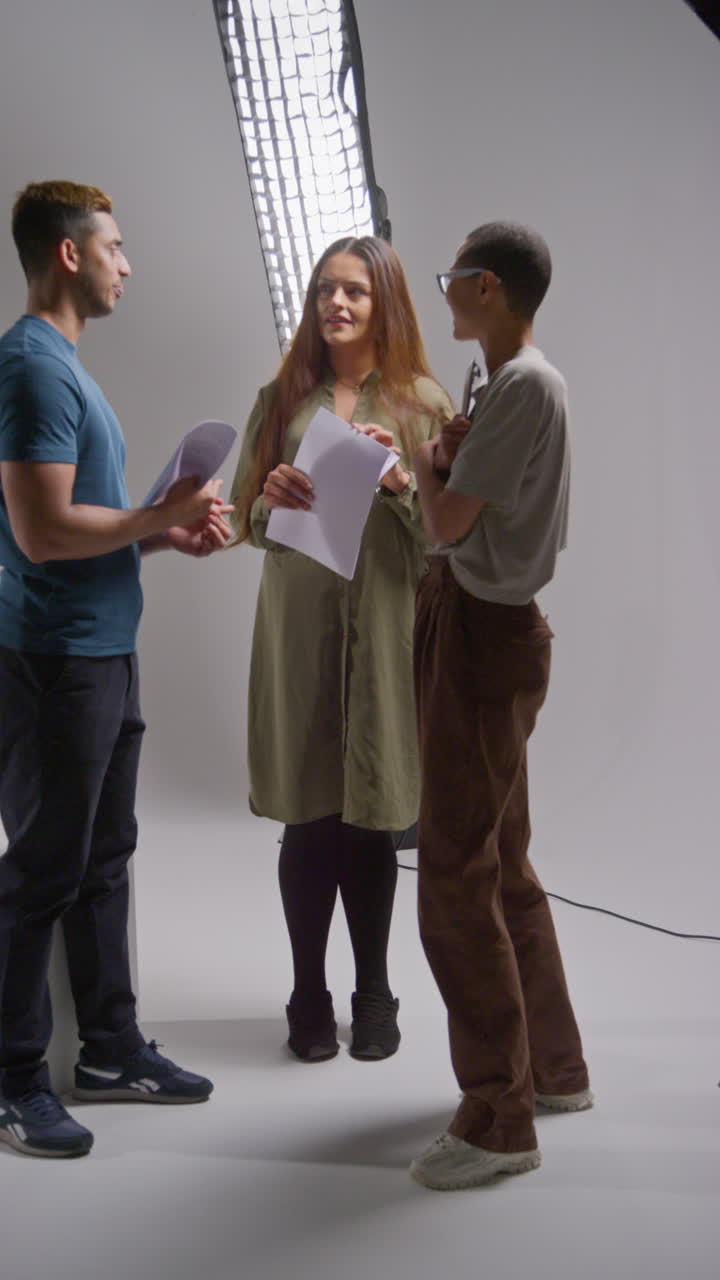 Free stock video - Actors discussing a script on a film set