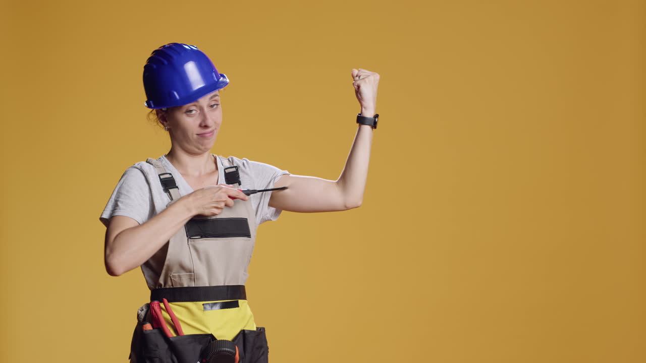 Strong empowered woman flexing arm muscles in studio | Premium Stock ...