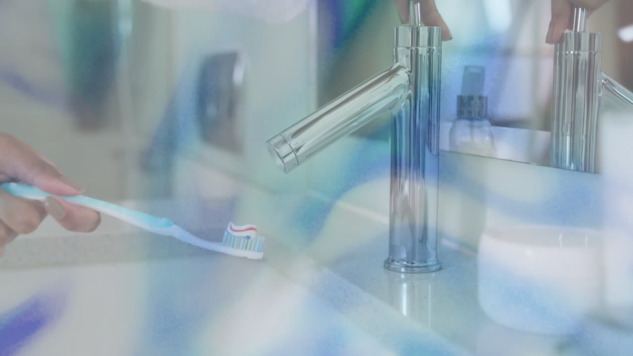 animation of light spots over biracial woman brushing teeth | freepik
