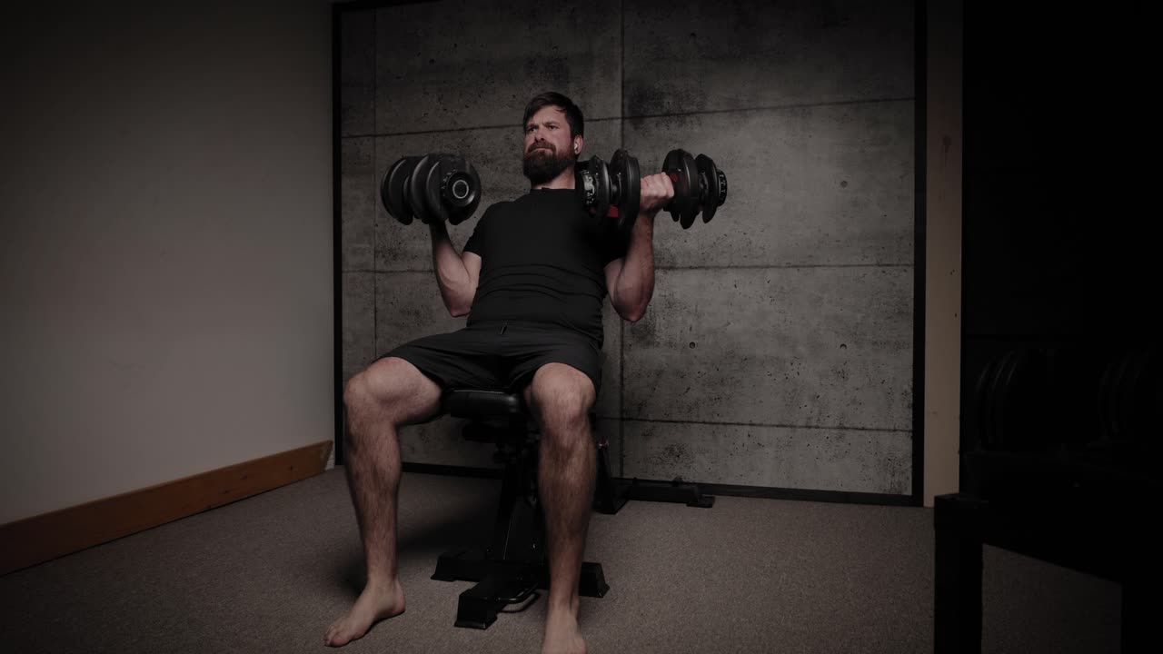 Premium stock video - Seated incline dumbbell curls, cinematic lighting ...