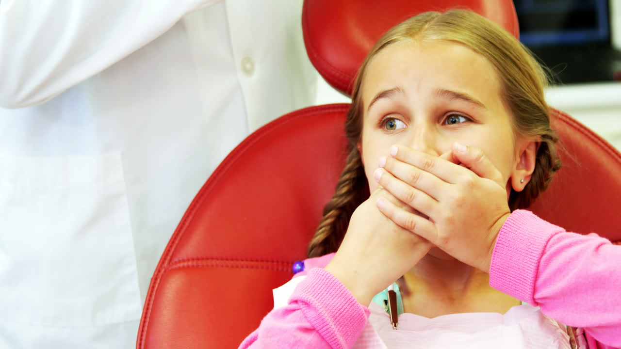 Premium stock video - Young patient scared during a dental check-up