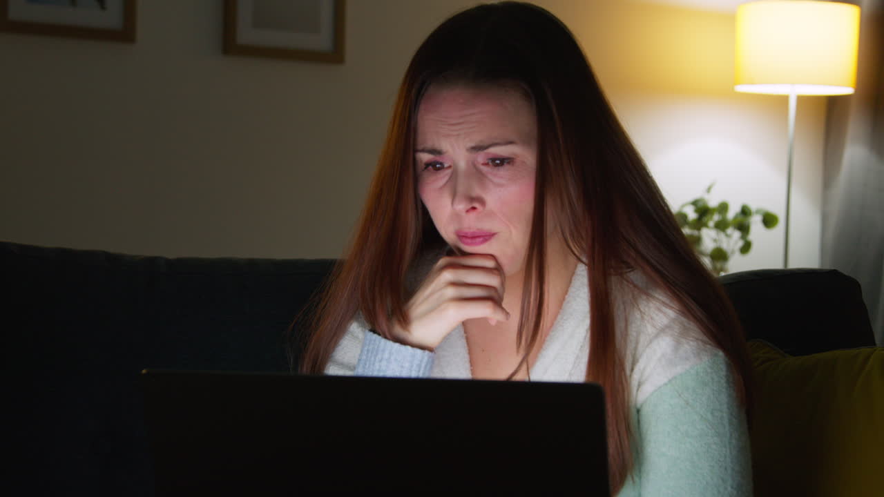 Free stock video - Anxious woman sitting on sofa at home at night ...