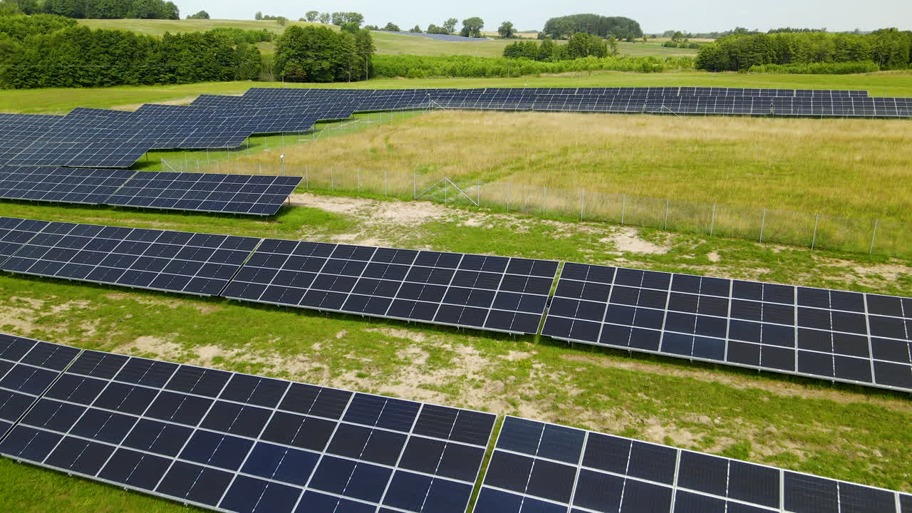 Low Angle Flight Over Modern Solar Panel Cells Installed On Green ...