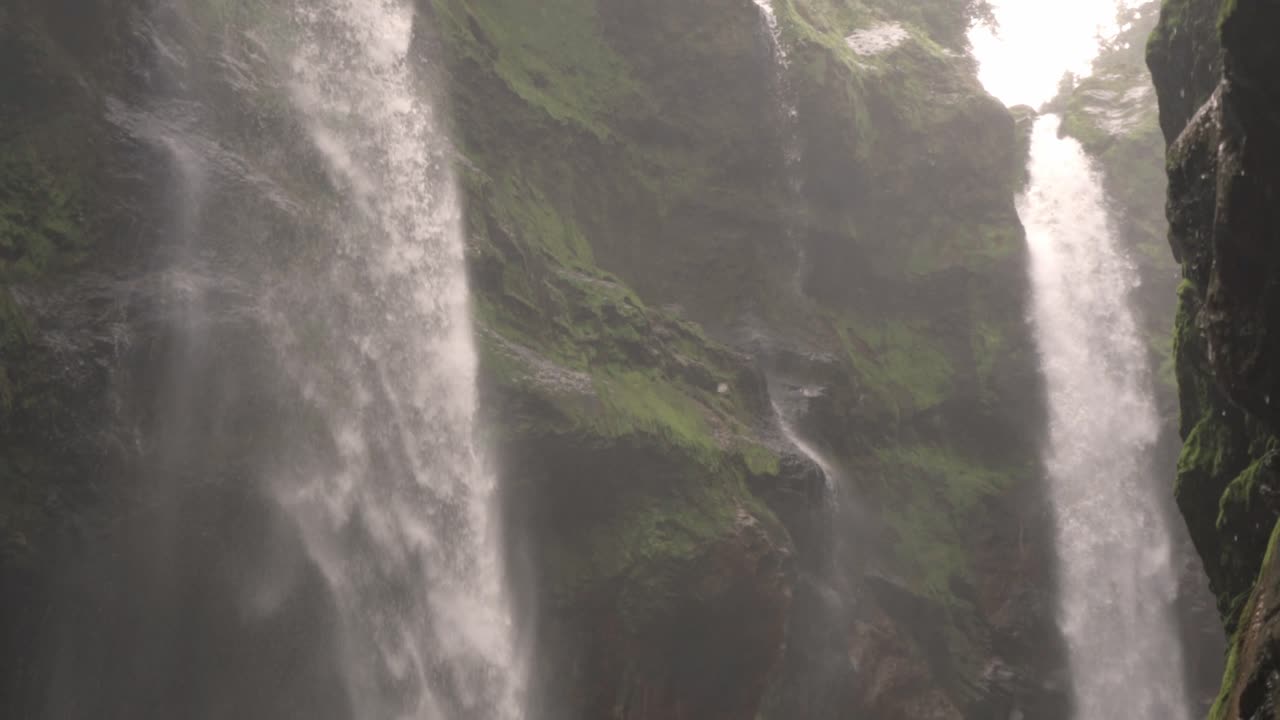 Powerful waterfall Quebrada Gata cascading down a moss-covered, rocky ...
