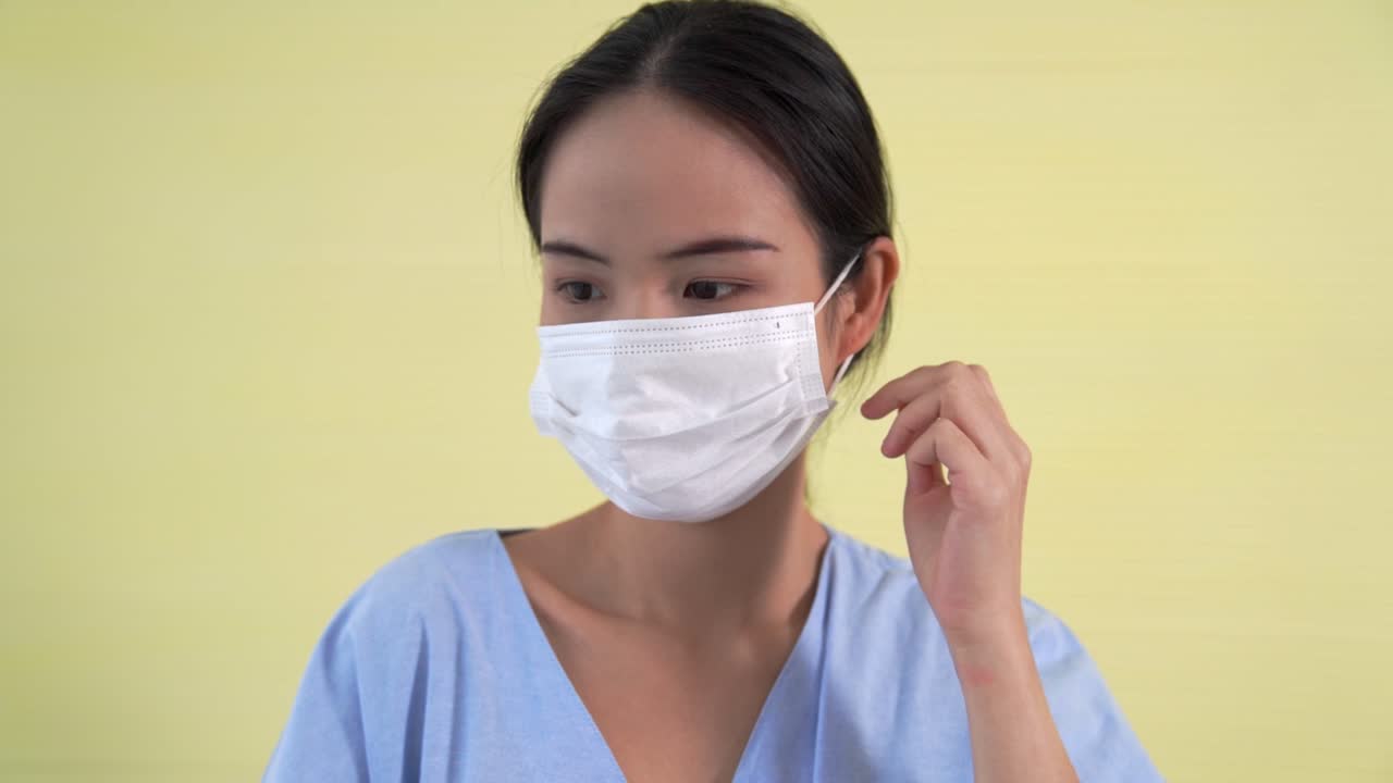 Premium stock video - Young asian woman take off face mask removing ...