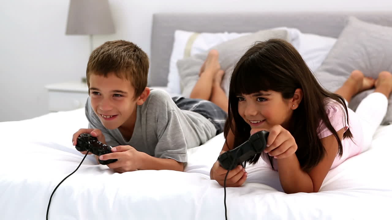 Premium stock video - Two children playing video games