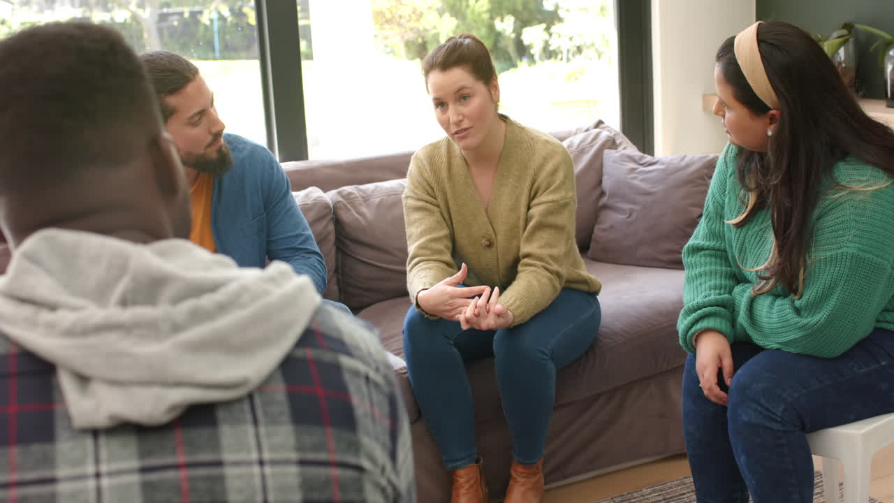 Diverse group of friends talking and supporting each other in group ...
