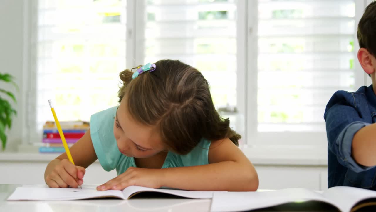 Premium stock video - Two children doing homework together