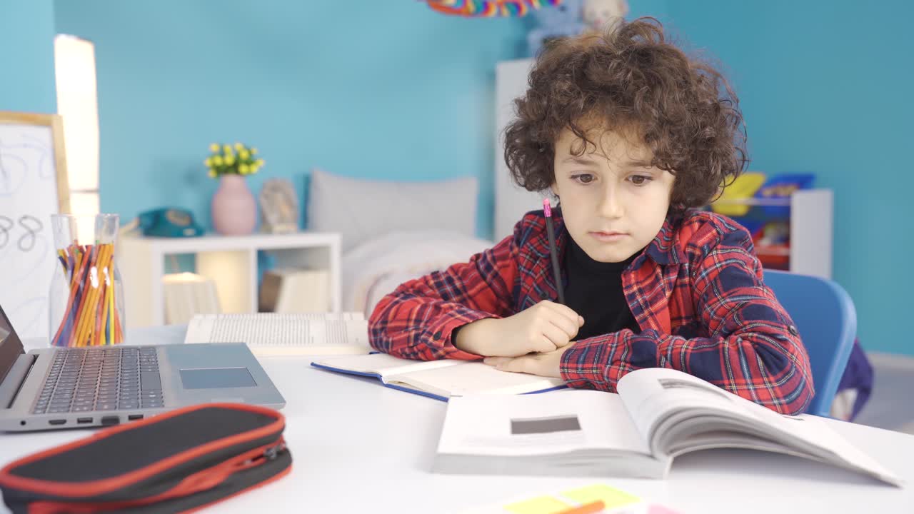Premium stock video - Happy boy studying at his desk. primary school ...
