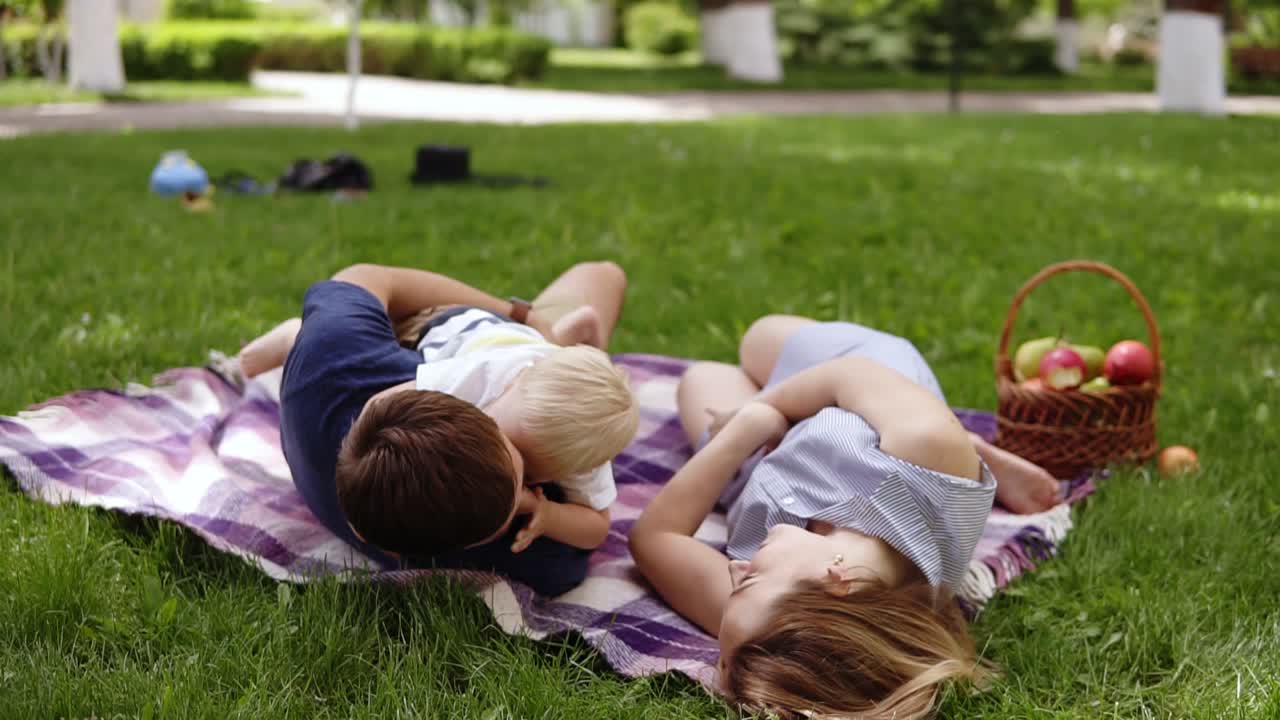 Premium stock video - Loving young family with little son have a picnic ...