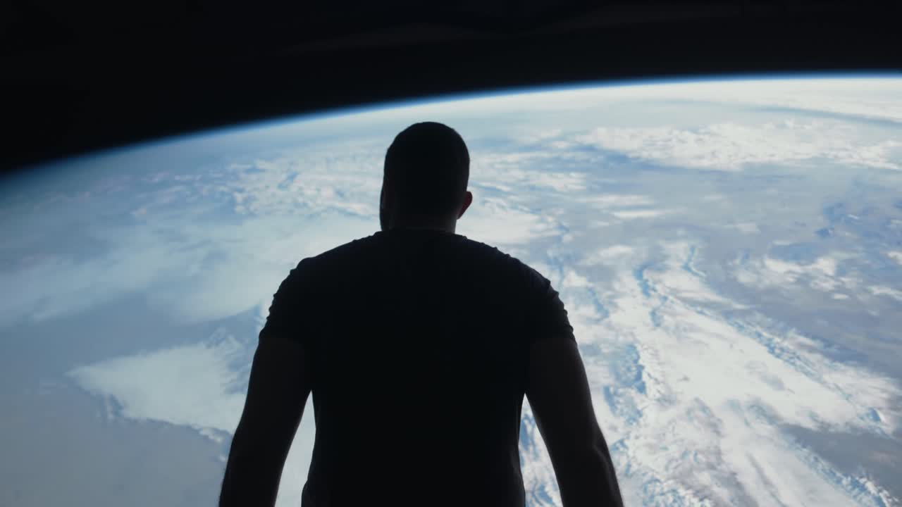 Man Looking at Earth from Space | Premium Stock Video Footage