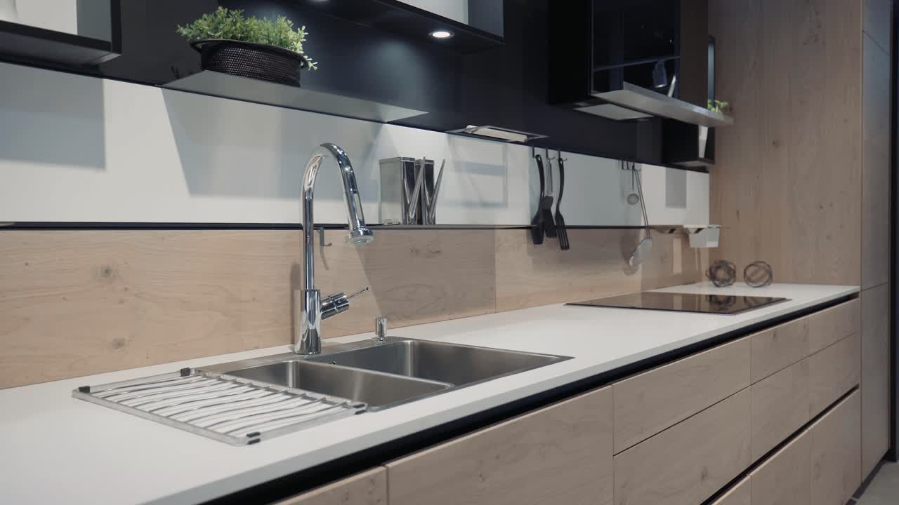 Premium stock video - A wood kitchen showroom gimbal shot bench and faucet