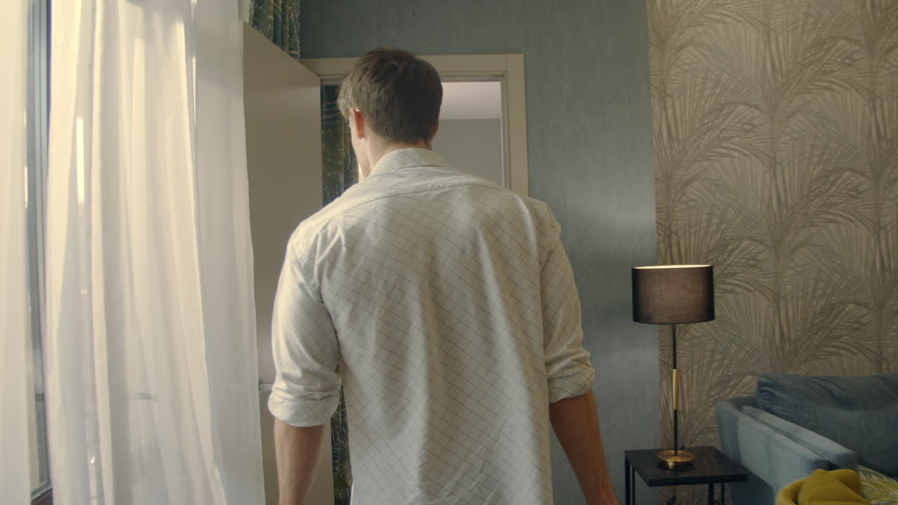 Handsome guy coming in luxury apartment | Free Stock Video Footage