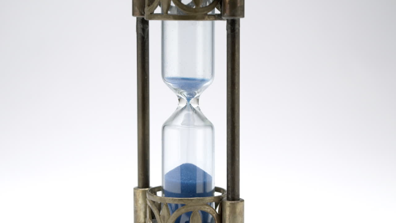Premium stock video - Old hourglass counting down tilt