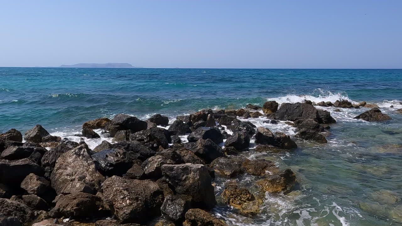Premium stock video - The turquoise sea spills onto the beach of crete
