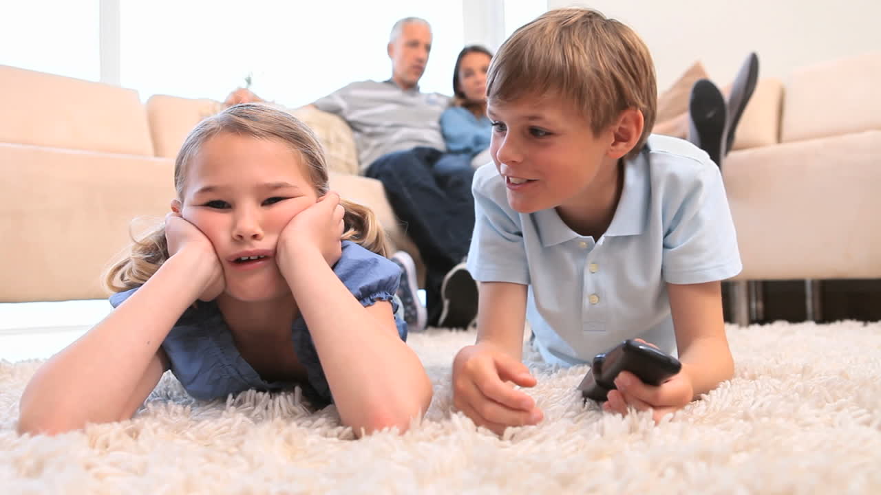 Children watching the television with their parents | Premium Stock ...