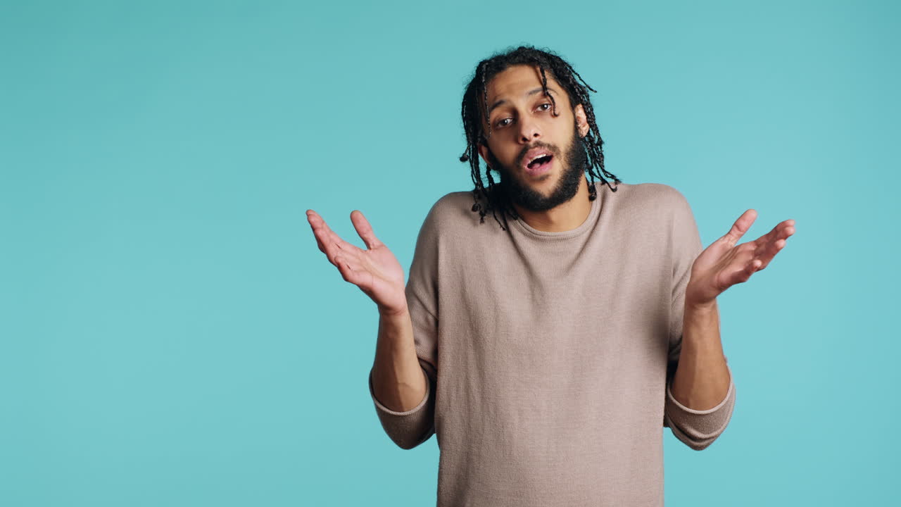 Premium stock video - Uncaring man shrugging shoulders, showing ...