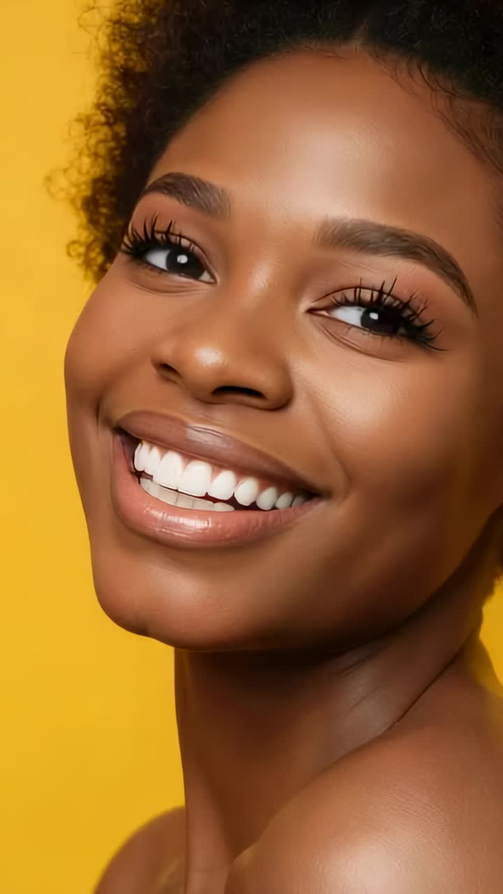 Vertical video: Smiling model tilting head and gazing at camera for ...