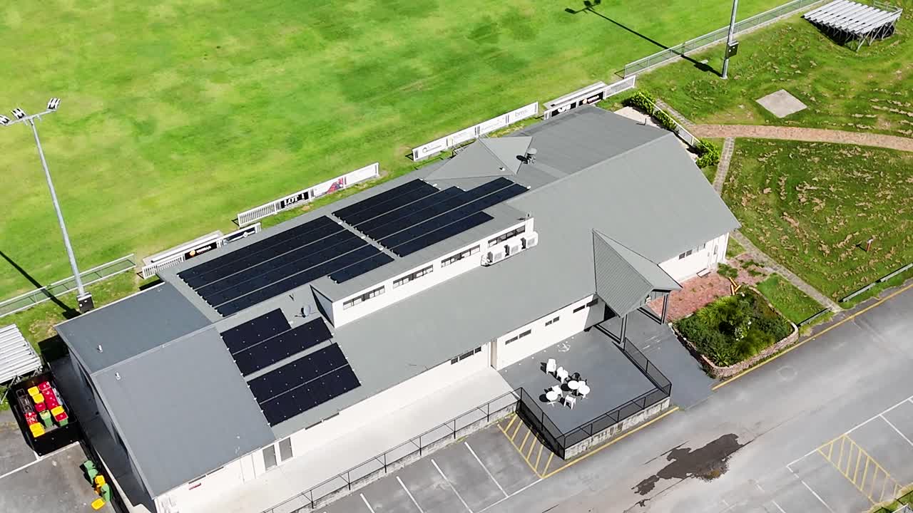 Aerial view of a sports building and field | Premium Stock Video Footage