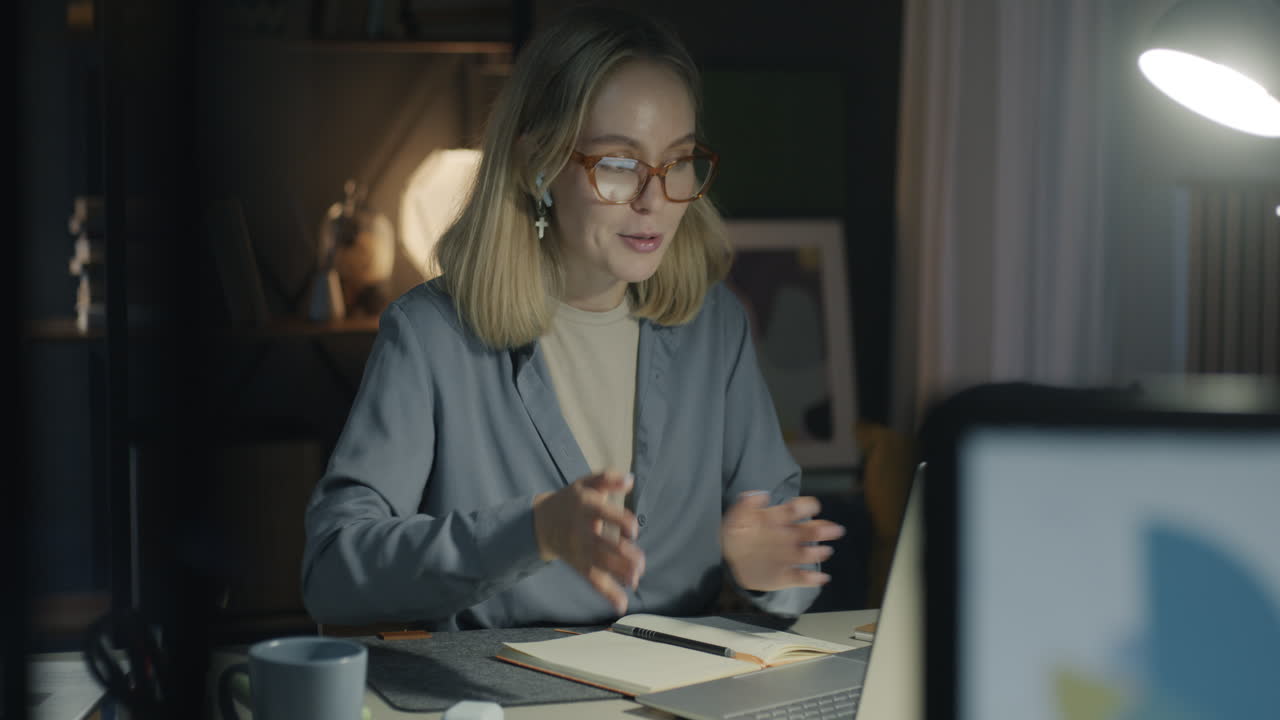 Woman having a video call at night in her home office | Premium Stock ...