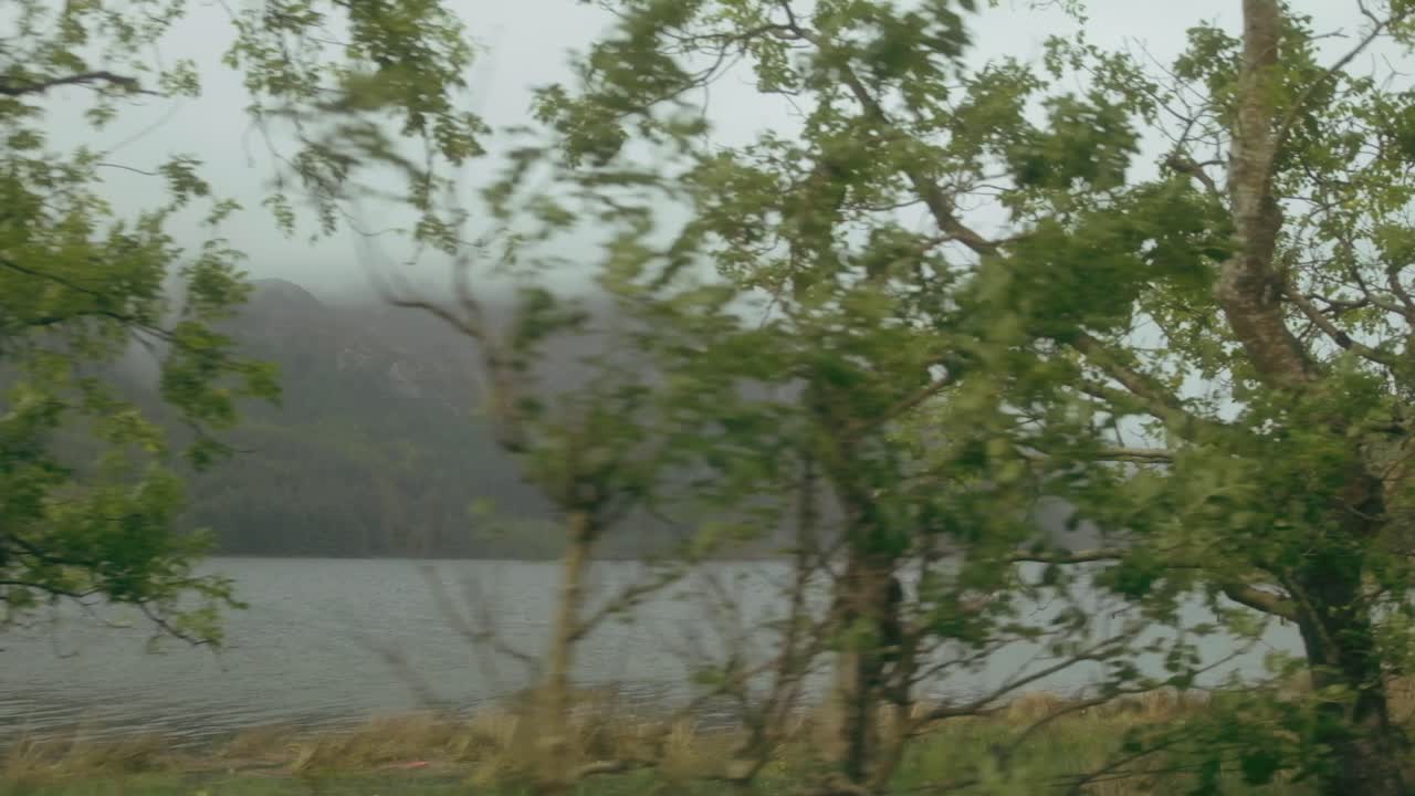 Slow-motion drive along a misty mountain lake, UK | Premium Stock Video ...