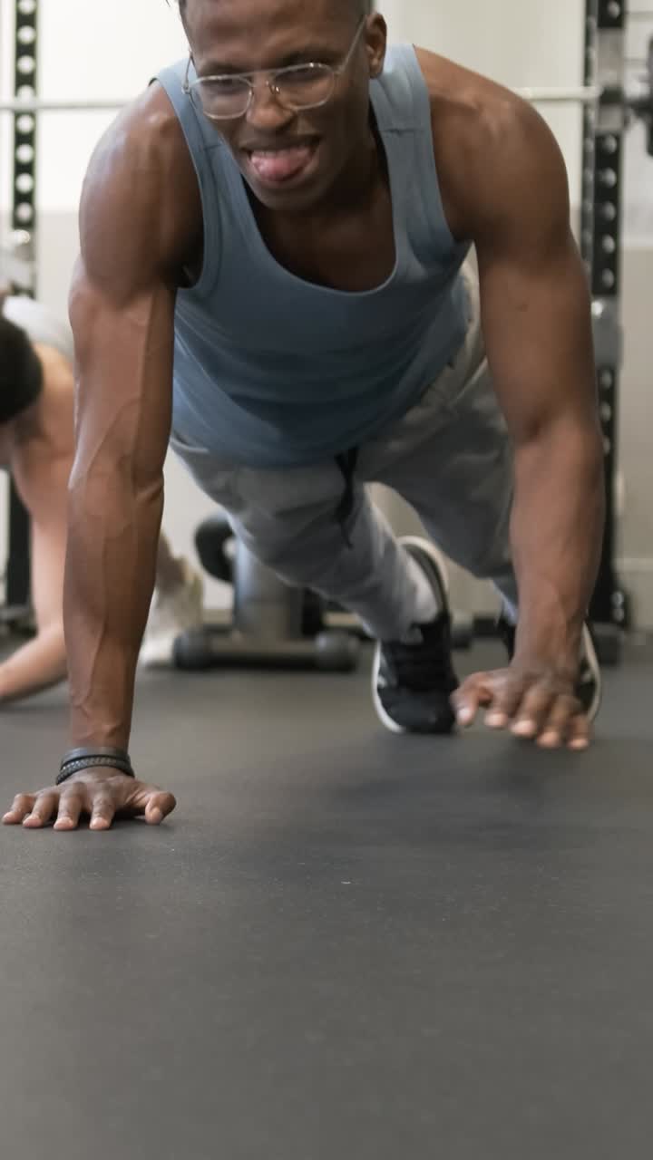 People doing push-ups in a gym | Premium Stock Video Footage