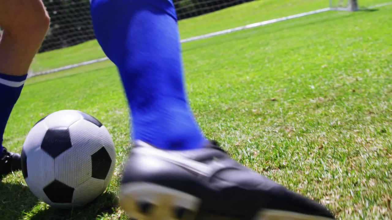 Premium stock video - Football player playing football in the field