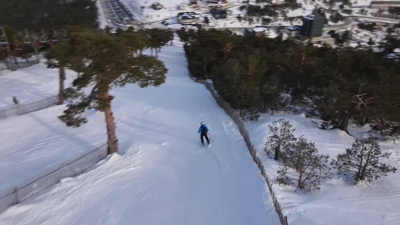 Aerial top-down view following skier from behind going Premium Stock ...