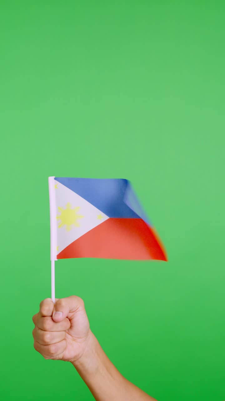 Hand lifting a philippine pennant while waving by the wind | Premium ...