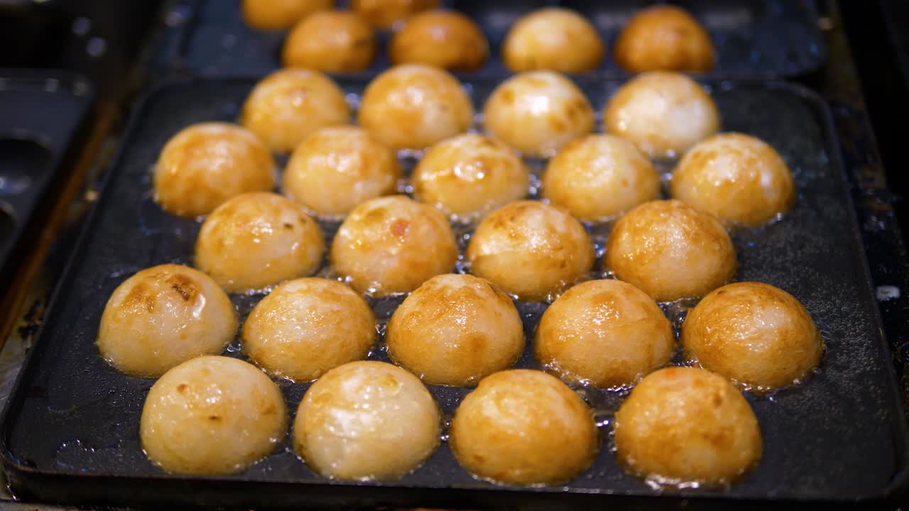 Premium stock video - A medium shot of deep fried dough balls