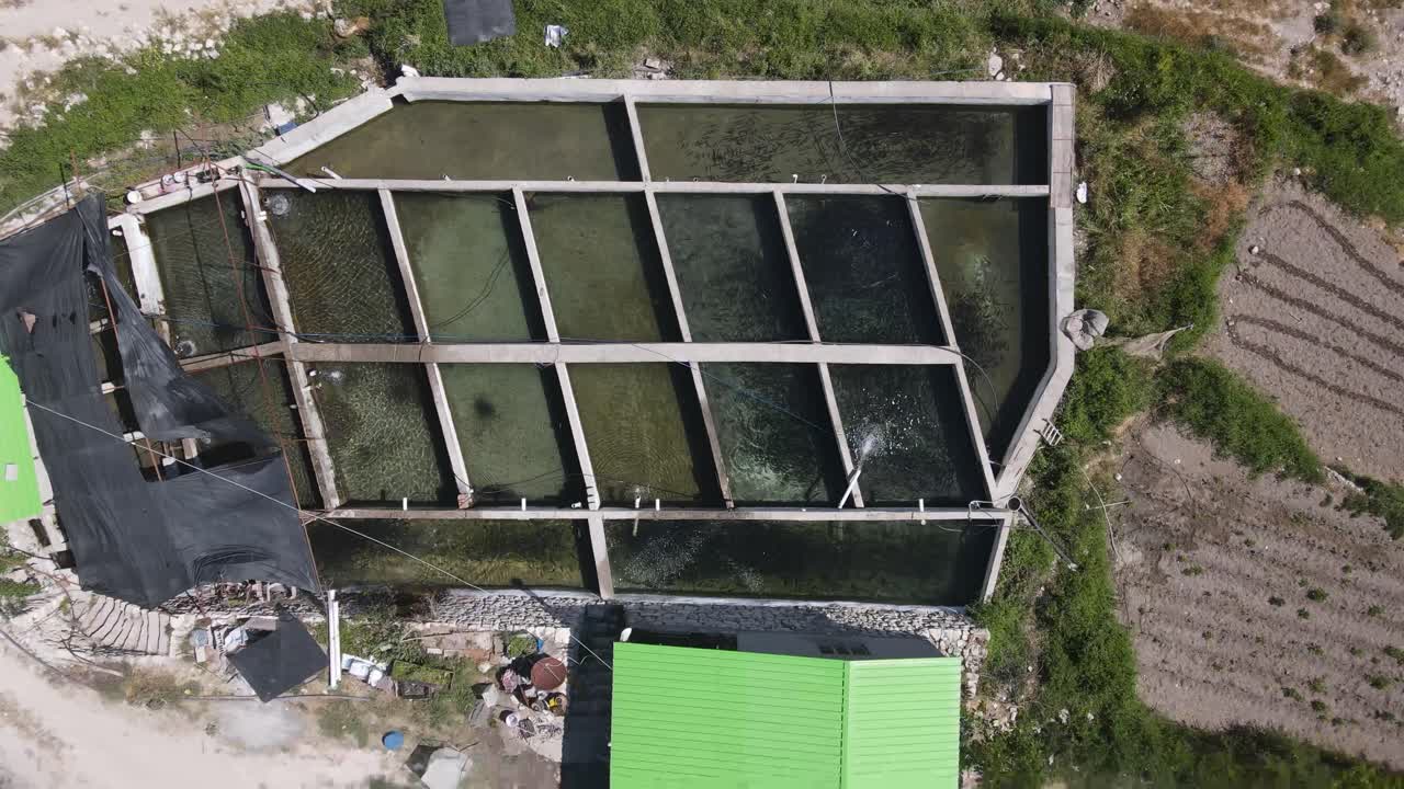 Premium stock video - Fish pond soaring overhead view