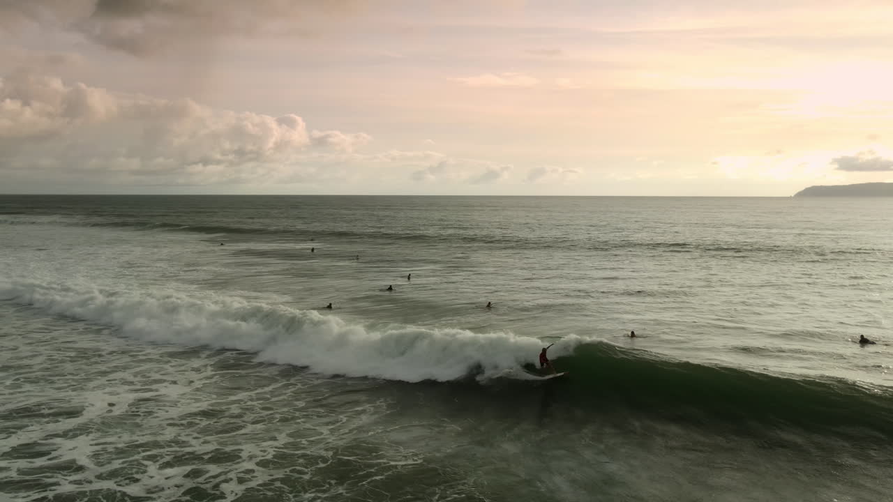 Free stock video - White-foamed sea churns as surfers ride the waves.