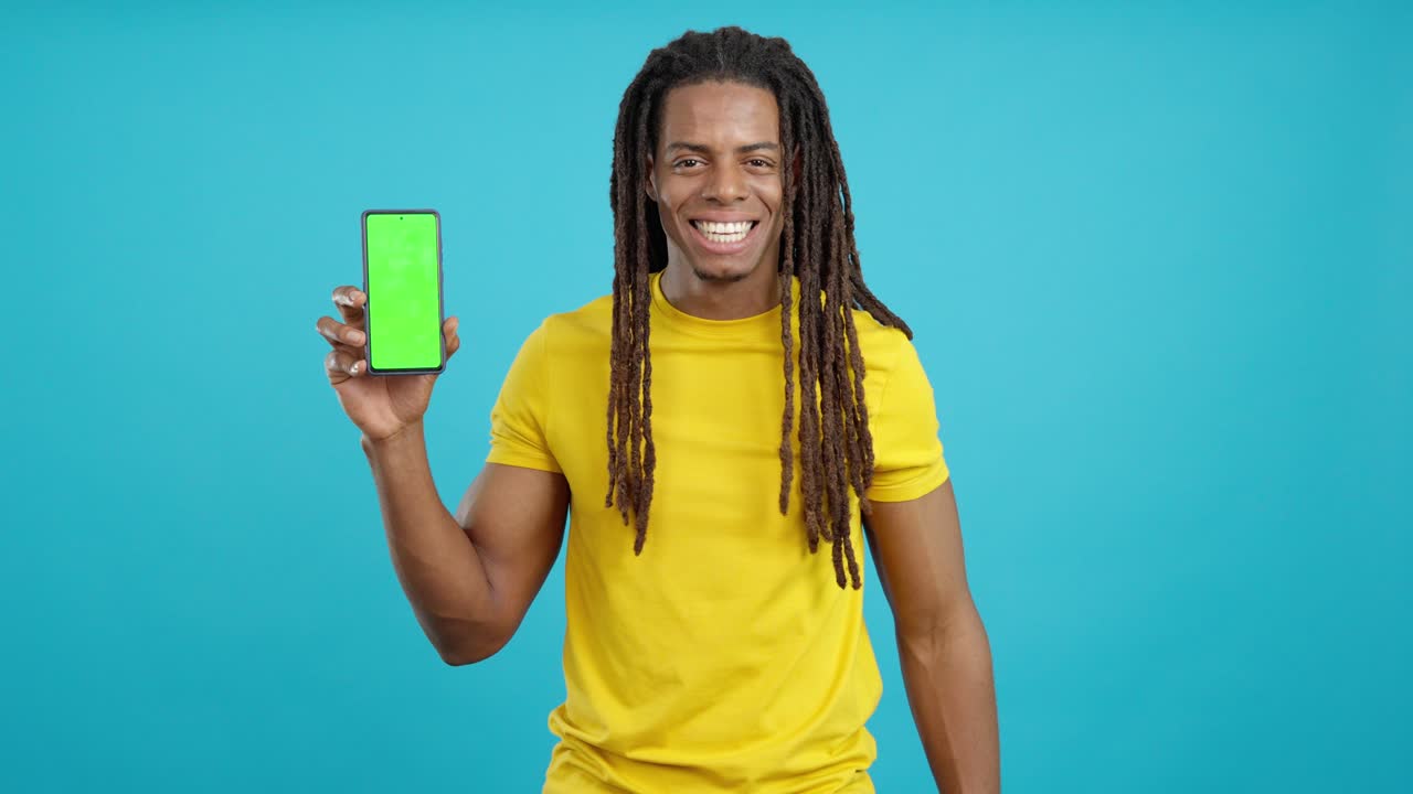 Man with dreadlocks holding phone with green screen | Premium Stock ...