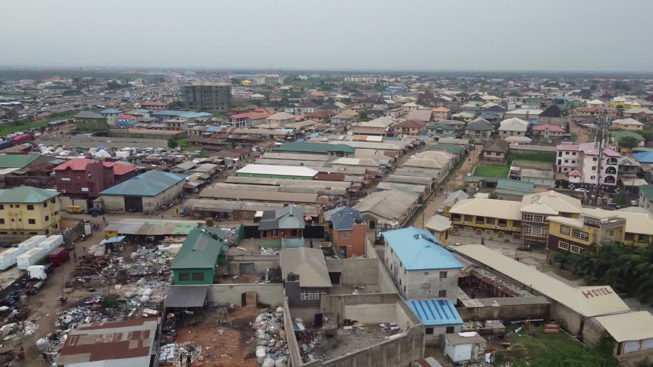 Aerial View Small Community In Lagos Nigeria And Drone Moving To Reveal An Industry, A Bus Park ...