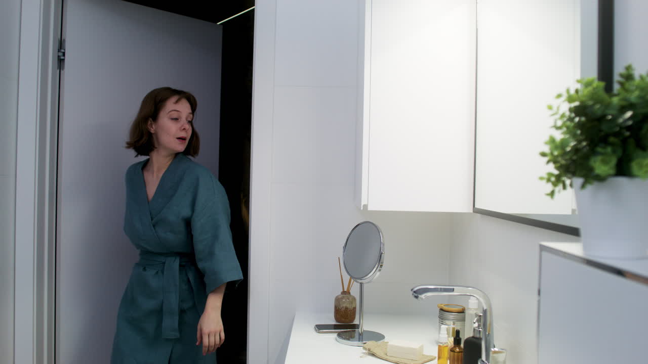 Woman entering the bathroom | Free Stock Video Footage