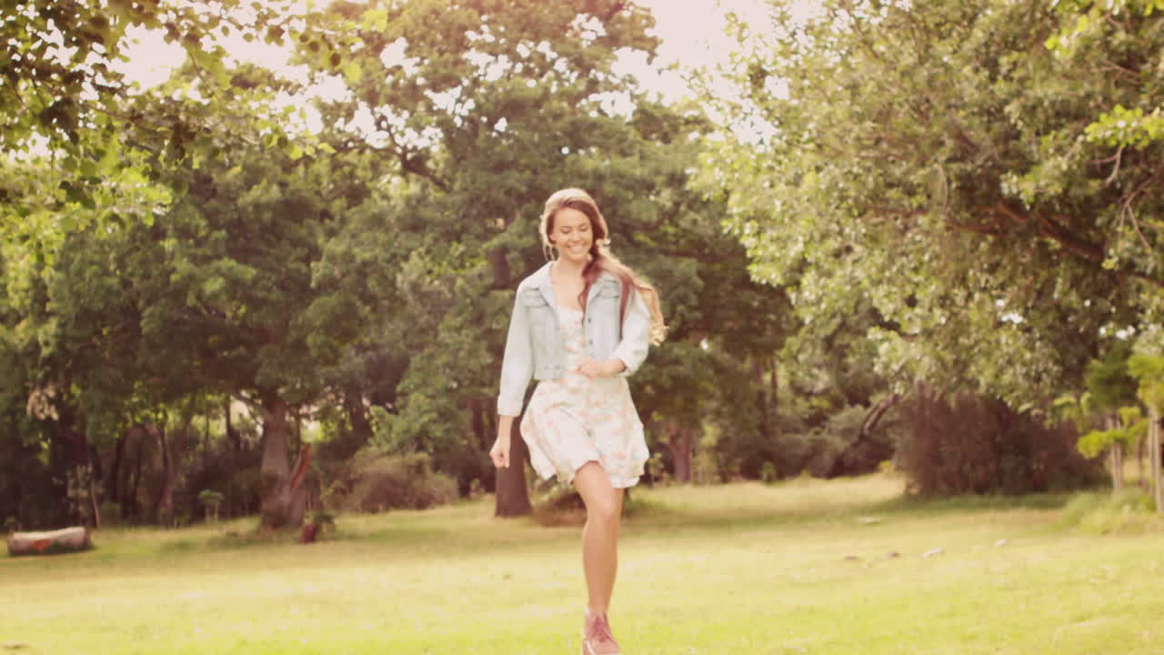 Premium stock video - In slow motion hopping girl in the park