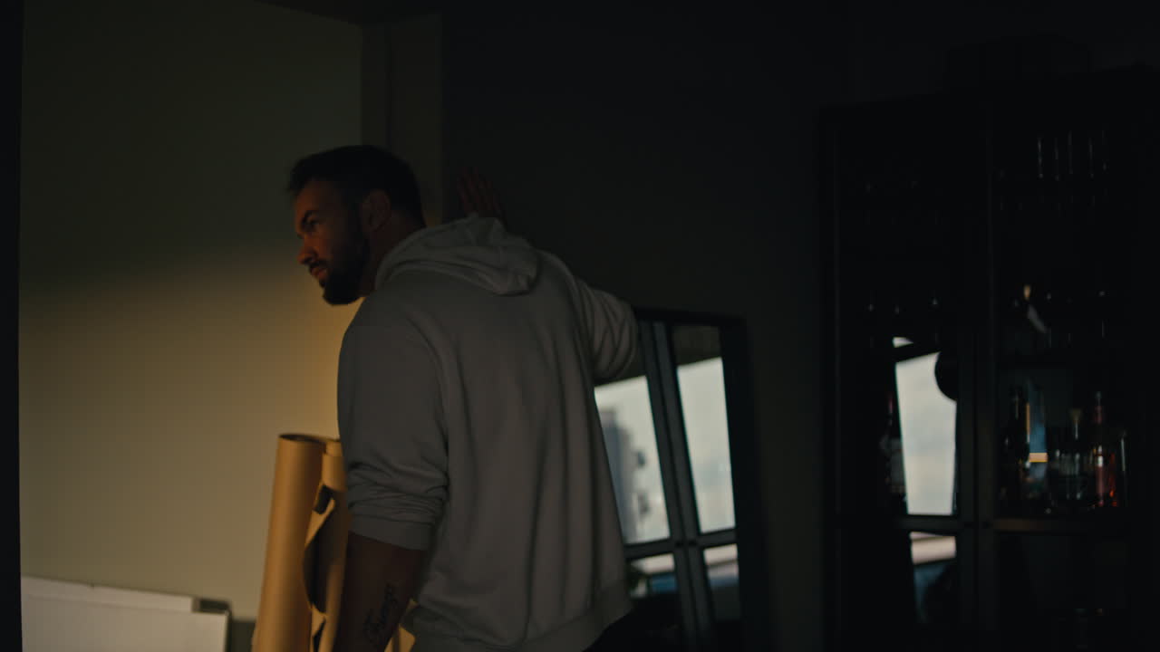 Premium stock video - A person walking by and peering around a