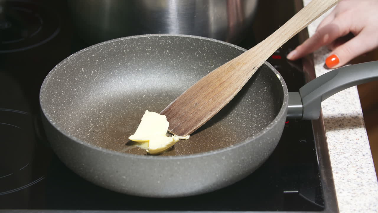 Free stock video - Melting butter on hot pan