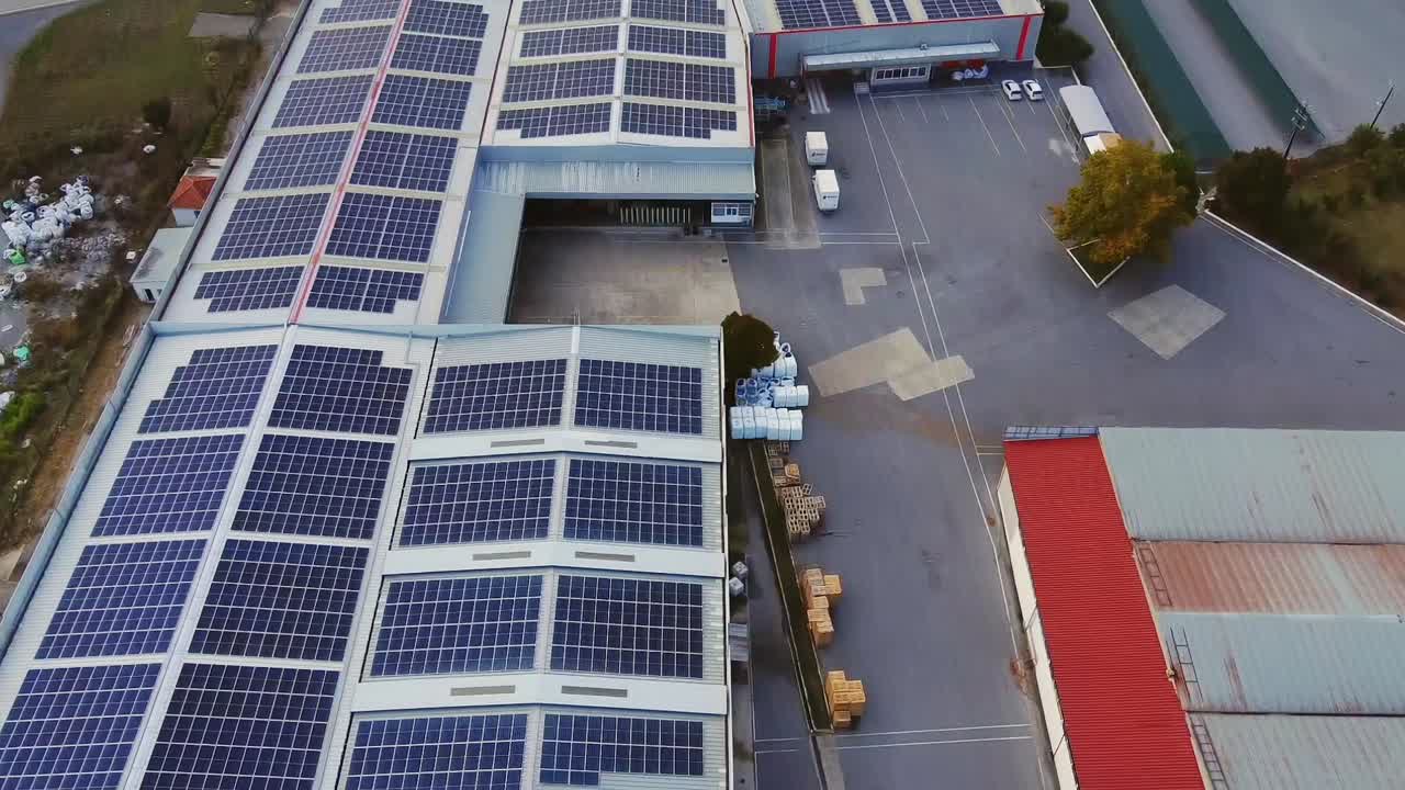 Logistics hub powered up by rooftop solar panel configuration, aerial ...