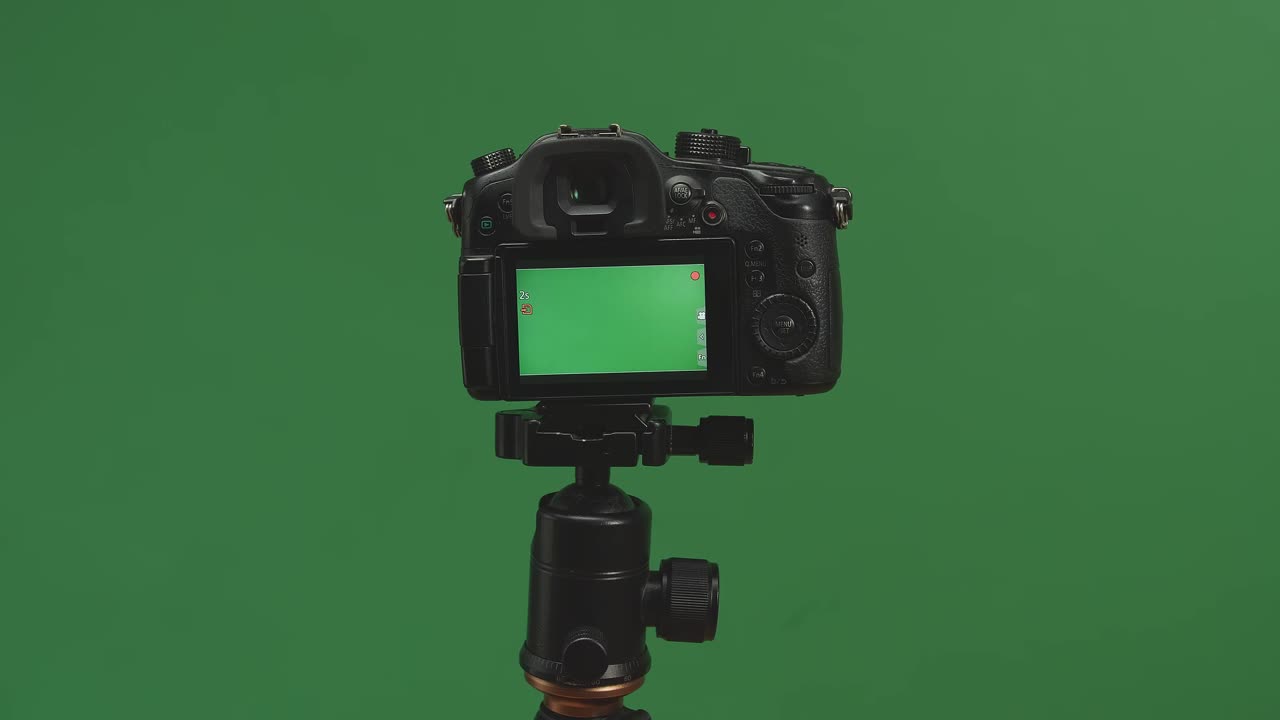 Male hand recording video with green screen display camera in green ...